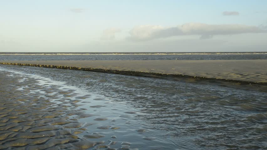 Stock Video Clip of Tideway at low tide at a beach | Shutterstock